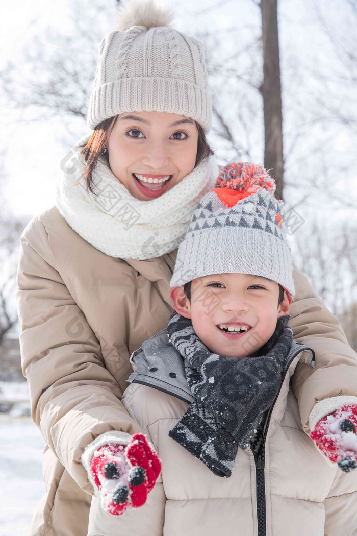 年轻妈妈和孩子在雪地上玩耍 包图企业站